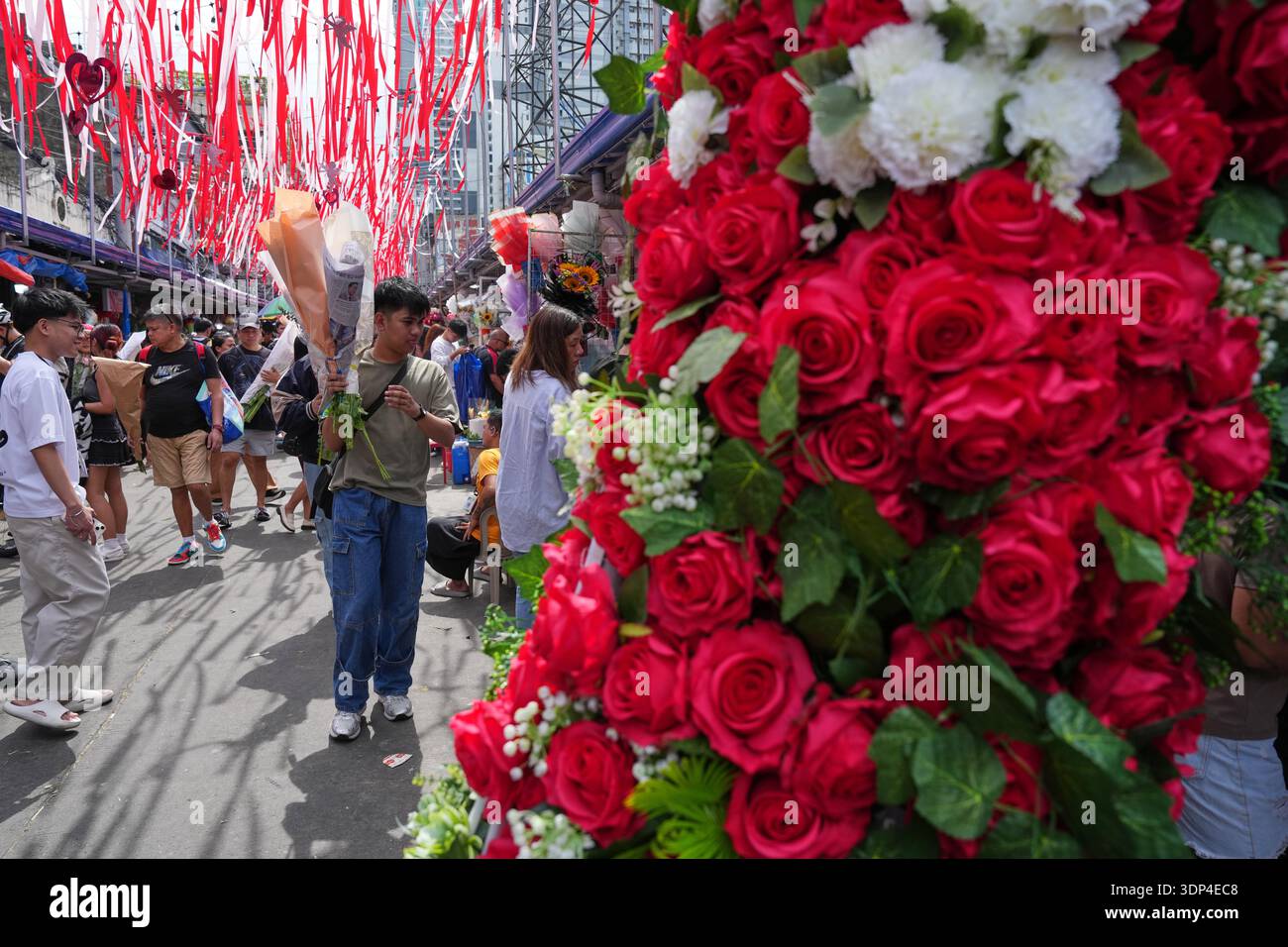 People flock at a flower market in Manila, Philippines as they prepare ...