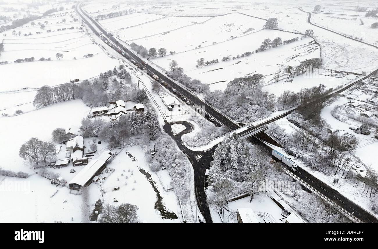 Cars and lorries on the A66 at Bowes in County Durham. Yellow weather ...