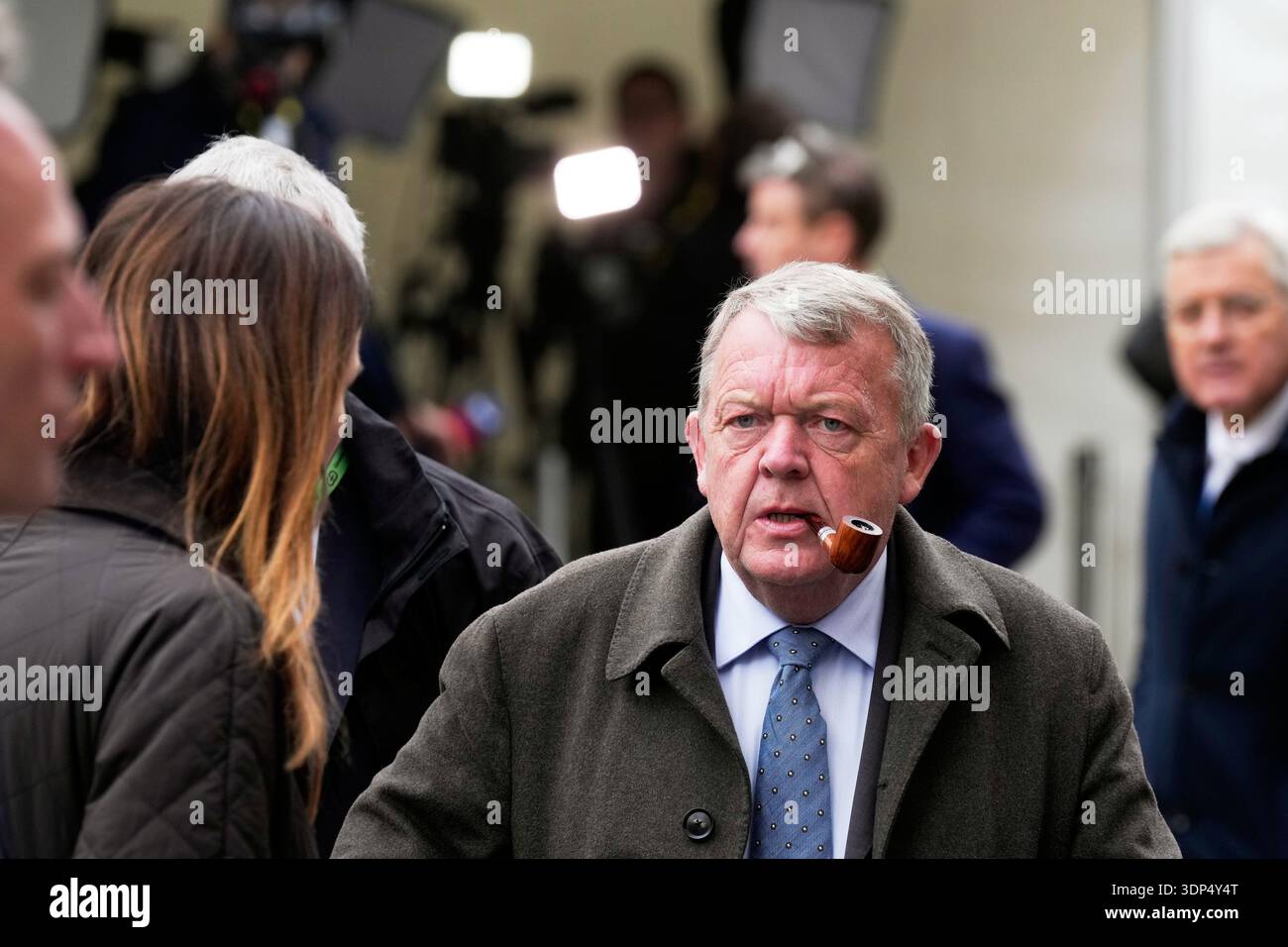 Denmark's Foreign Minister Lars Lokke Rasmussen smokes a pipe as he ...