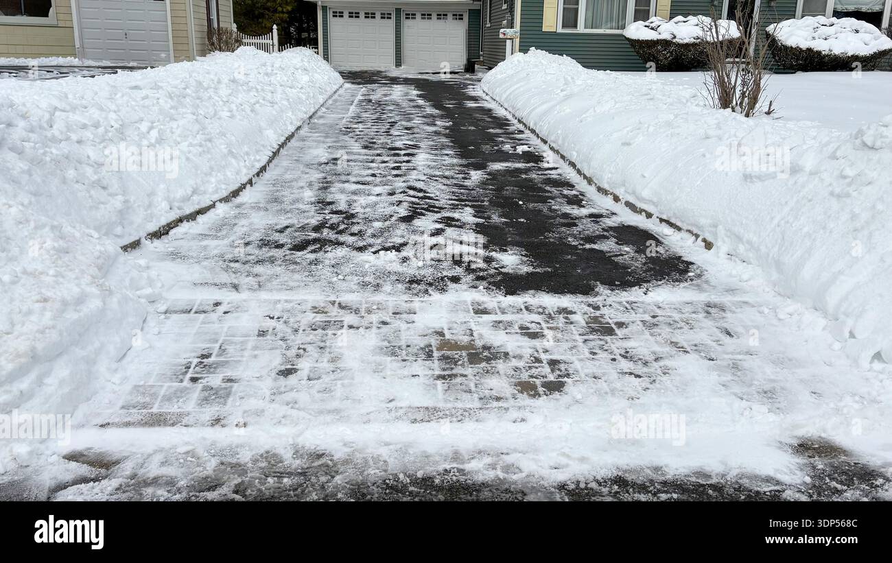 Snow piled high around a shoveled driveway after a snow storm on Long ...