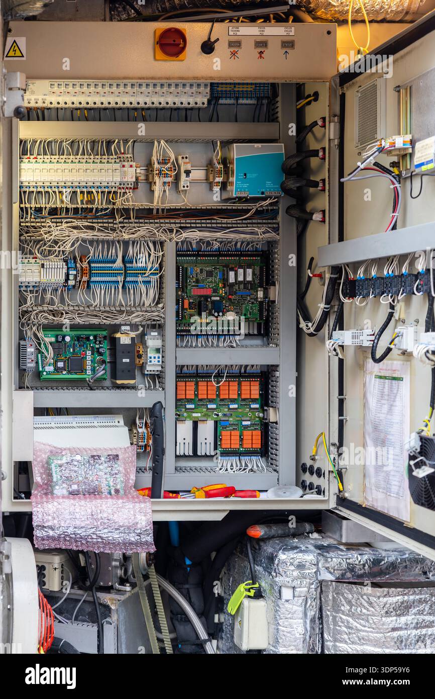Open industrial control cabinet PLC modules circuit boards breakers ...
