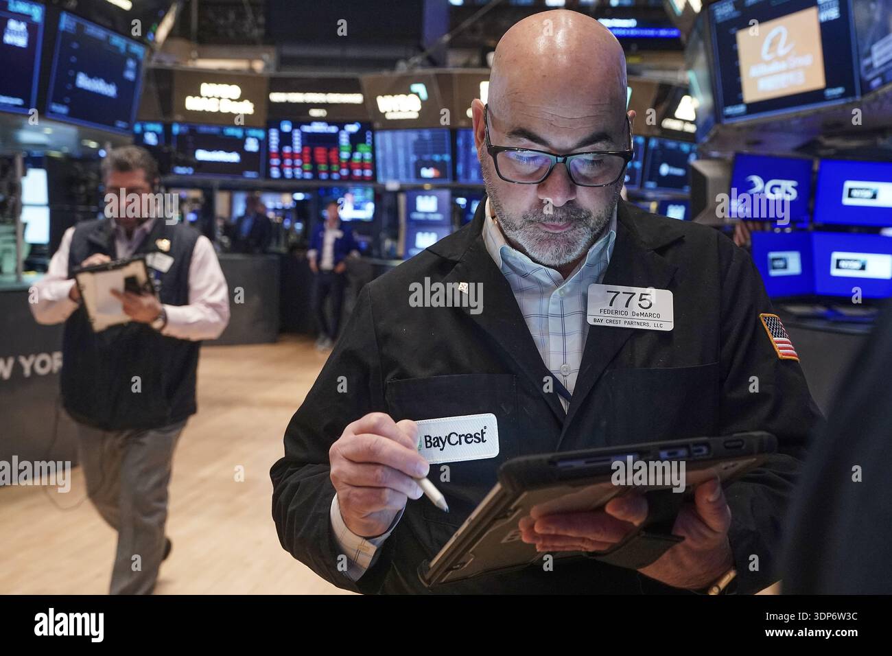 Trader Fred Demarco, right, works on the floor of the New York Stock ...