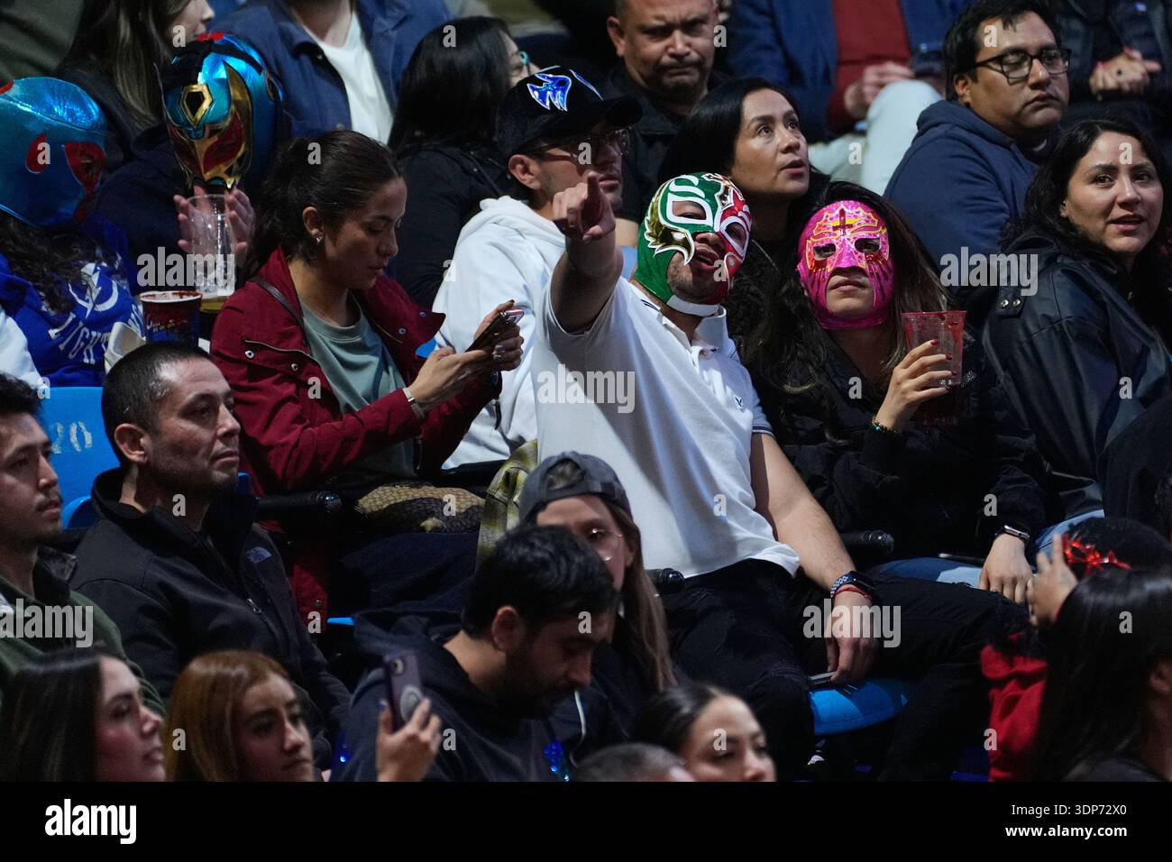 Wrestling fans wear masks during a live Lucha Libre performance at ...