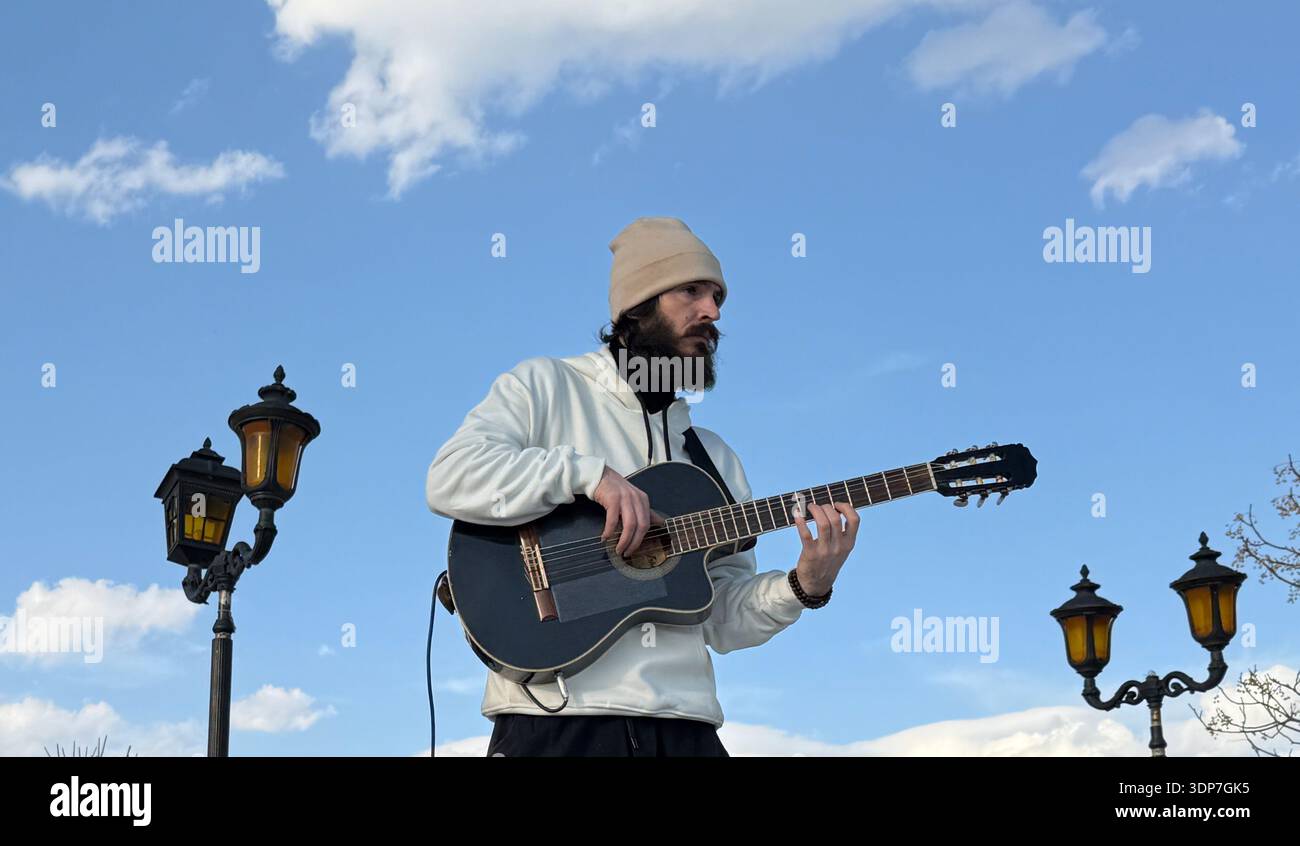 A street musician plays guitar at a park in Tehran, Iran, Friday, Feb ...