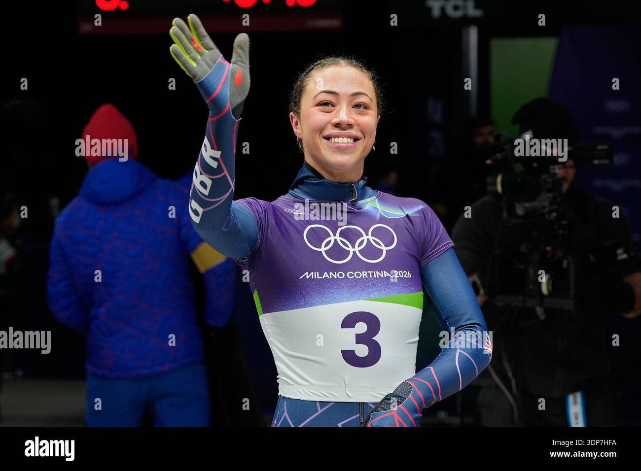 Britain's Tabitha Stoecker waves as she arrives at the finish during a ...
