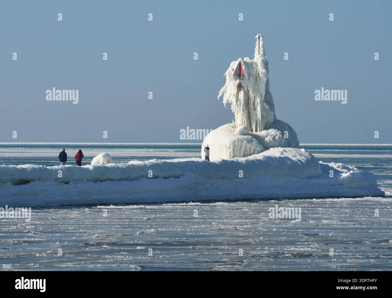Ice covers a navigational beacon at the end of the South Pier along ...