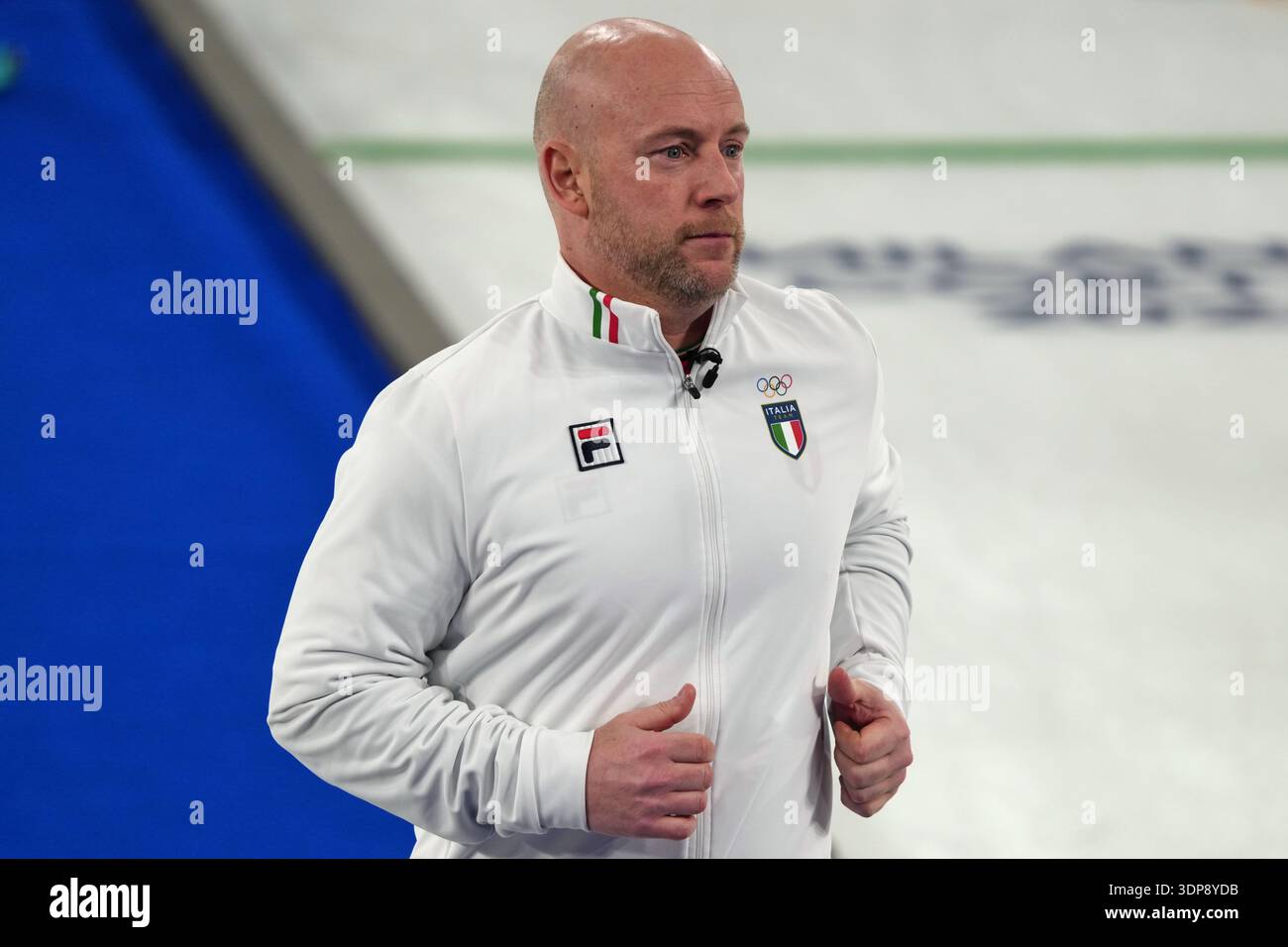 Italy's coach Ryan Fry walks after the men's curling round robin ...
