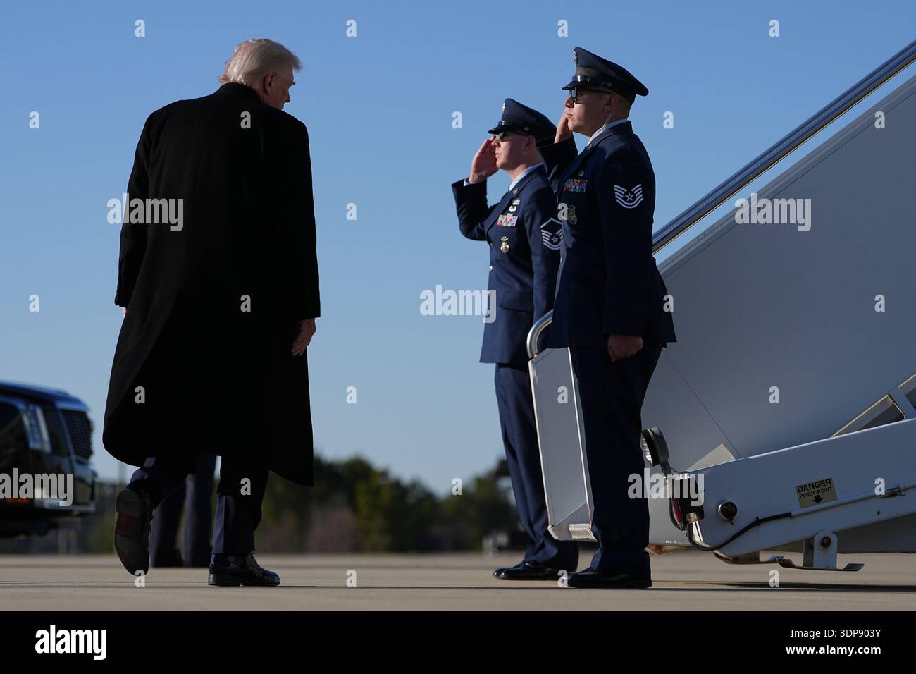 President Donald Trump walks to board Air Force One after speaking with ...
