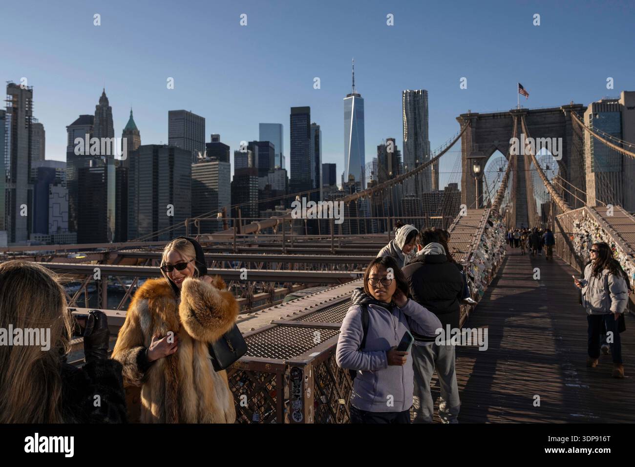 Pedestrians pose for a picture on the Brooklyn Bridge, Friday, Feb. 13 ...