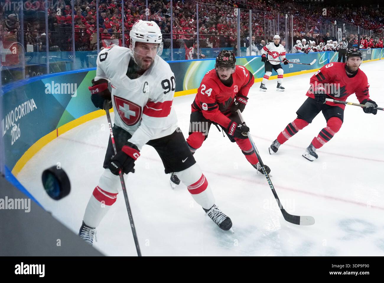 Switzerland's Roman Josi (90) and Canada's Seth Jarvis (24) skate after ...