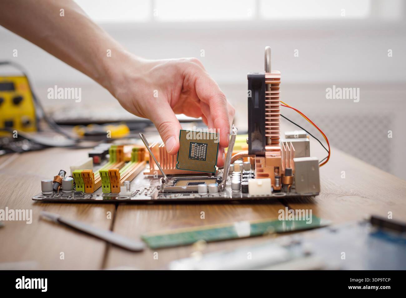 Hand Places CPU Onto Motherboard During Computer Assembly in a Work ...
