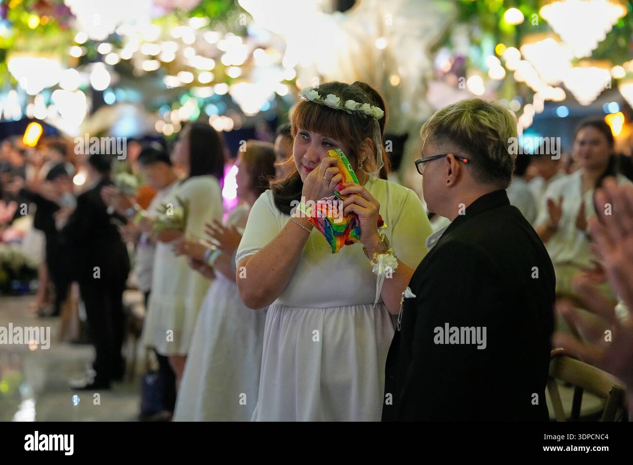 A woman wipes tears from her eyes during a LGBTQIA+ commitment ceremony ...