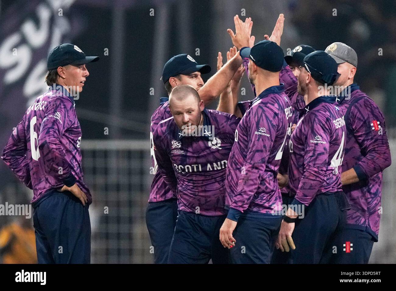 Scotland's Michael Leask, center without a cap, comes out of the group ...