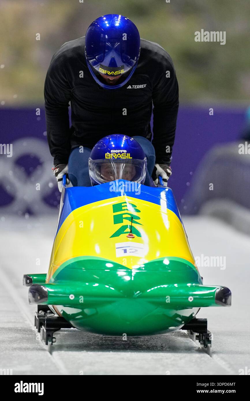 Brazil's Edson Luques Bindilatti, front, starts for a two man bobsled ...