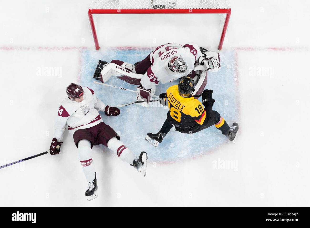 Germany's Tim Stutzle (18) challenges with Latvia's Arturs Silovs (31 ...
