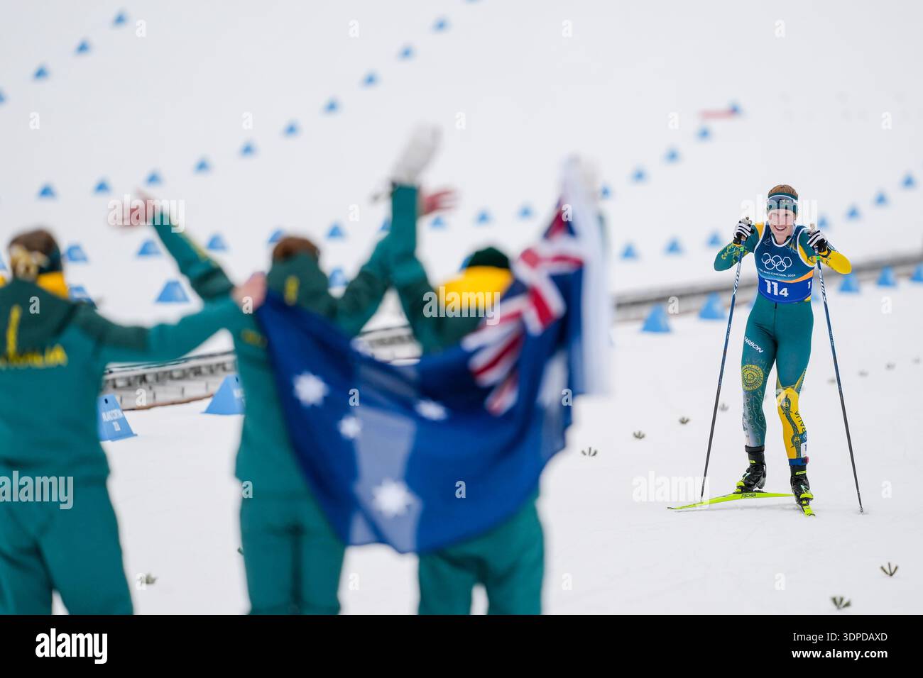 Maddie Hooker, of Australia, approaches the finish line and celebrating ...