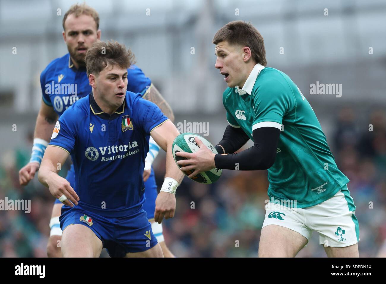 Ireland's Sam Prendergast, right, is challenged by Italy's Leonardo ...