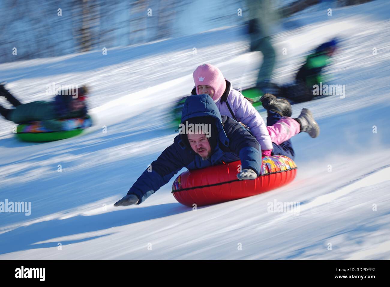 People slide down the hill in St. Petersburg, Russia, Saturday, Feb. 14 ...