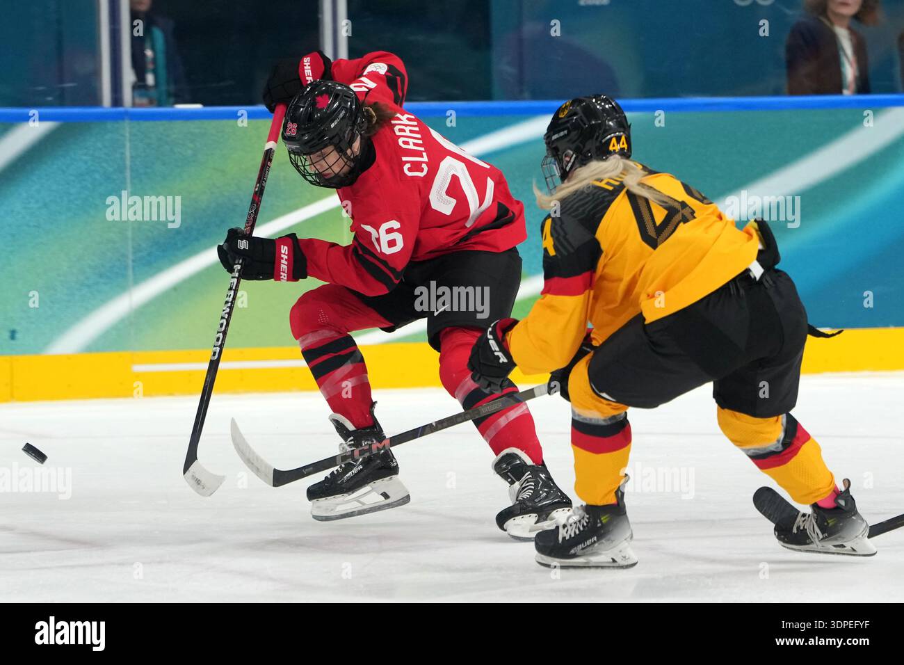 Canada's Emily Clark (26) and Germany's Hanna Hoppe (44) chase the puck ...