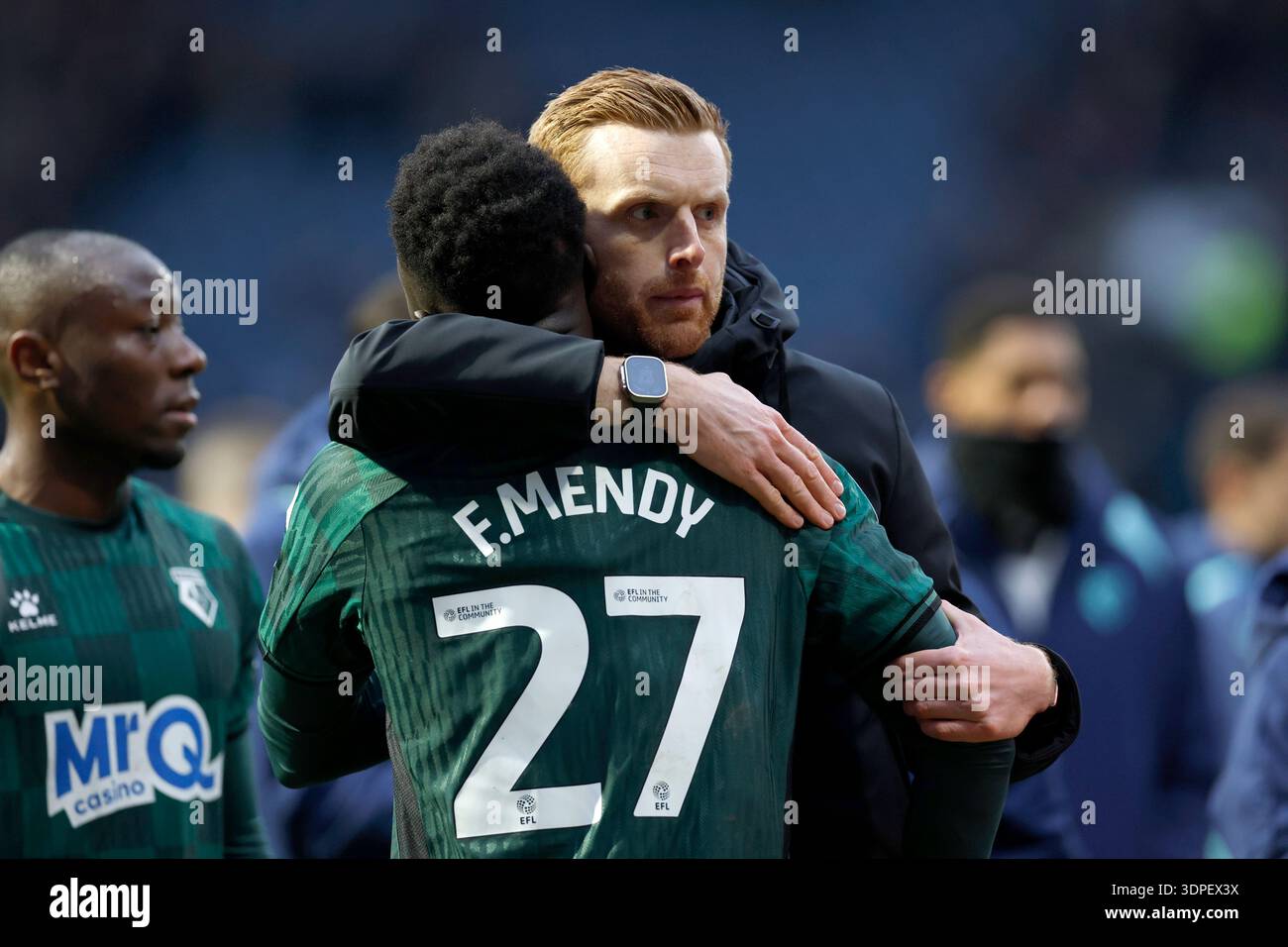 Watford manager Edward Still embraces Formose Mendy at full time ...