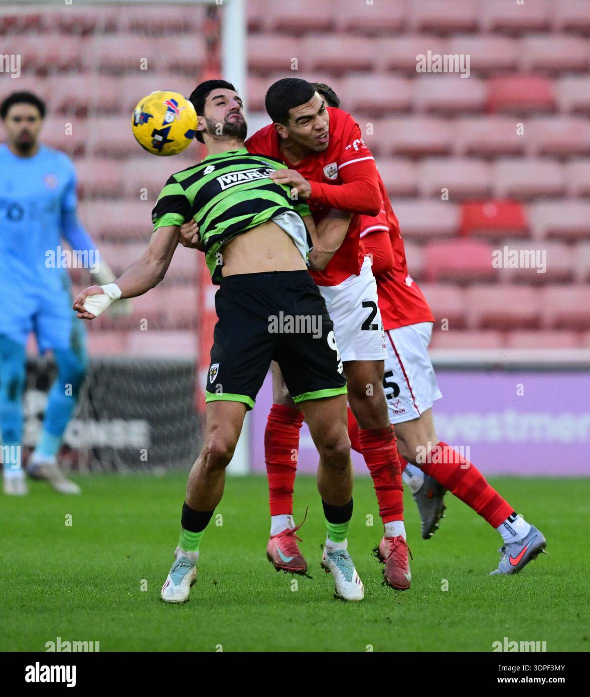 Barnsley's Tennai Watson has an aerial challenge with Wimbledon's Omar ...