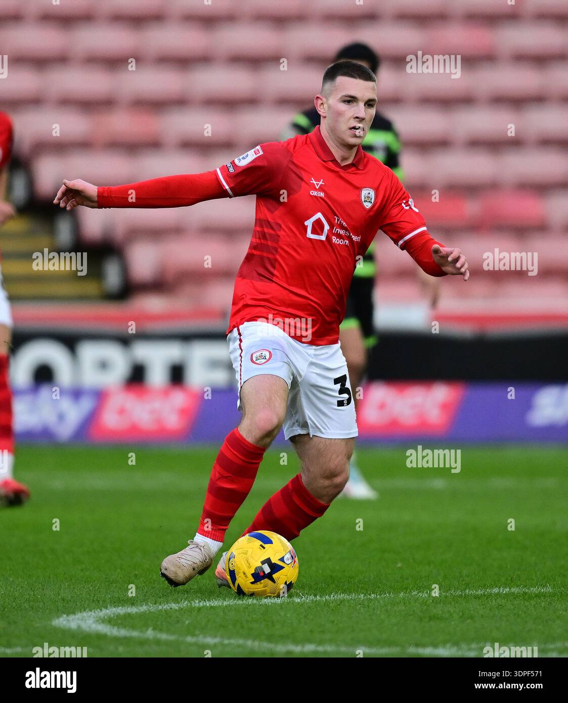 Barnsley's Jonathan Bland dribbles with the ball in the match between ...