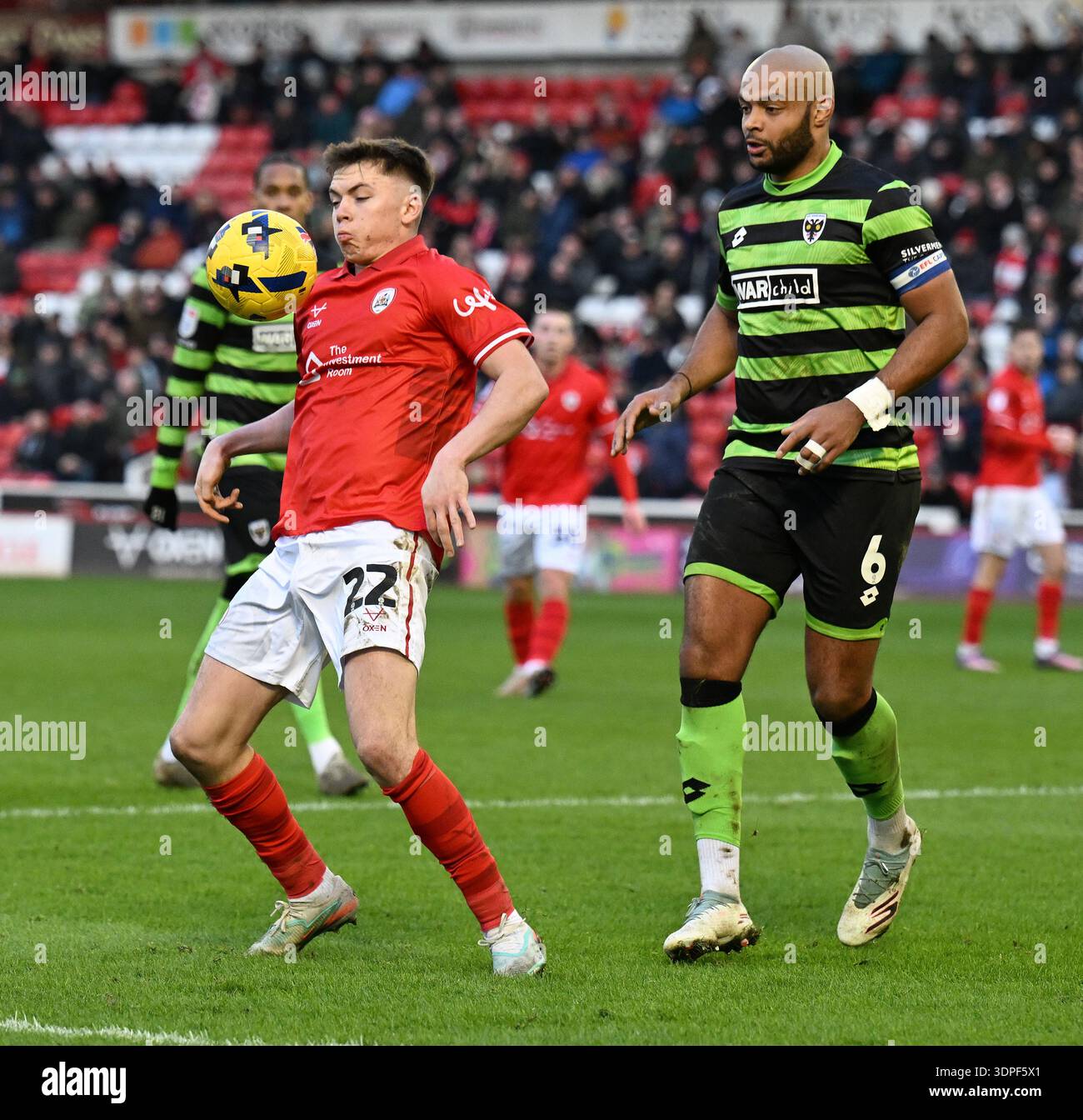 Barnsley's Patrick Kelly battles for the ball against Wimbledon's Ryan ...