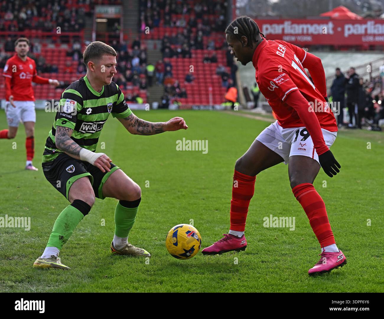 Barnsley's Reyes Cleary battles for the ball against Wimbledon's James ...