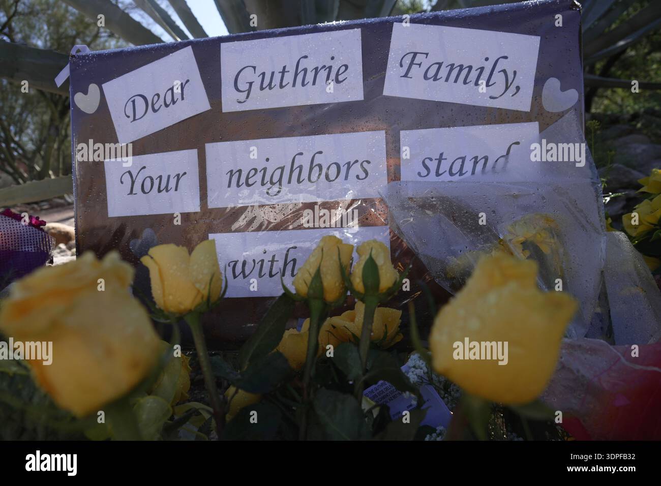 Yellow flowers and signs remain at a vigil outside of Nancy Guthrie’s ...