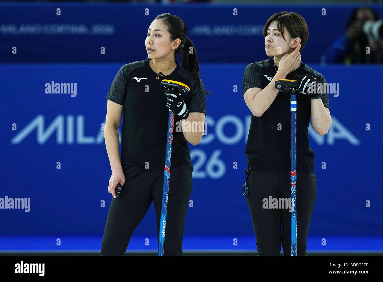 Japan's Anna Ohmiya and Kaho Onodera look on during the women's curling ...