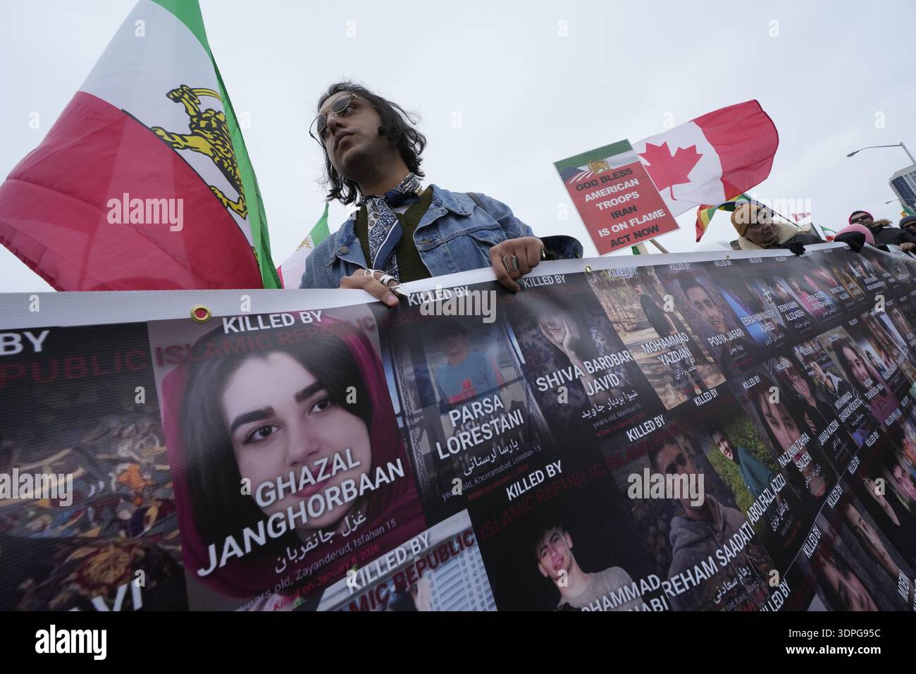 Supporters of Iran's exiled Crown Prince Reza Pahlavi carry a banner ...