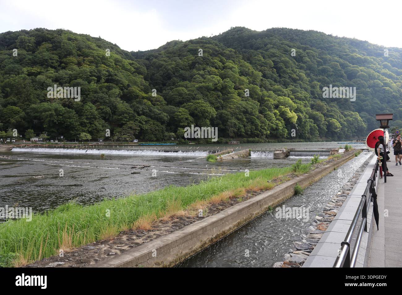 Riverside View Of The Katsura River And Forested Hillside In Arashiyama