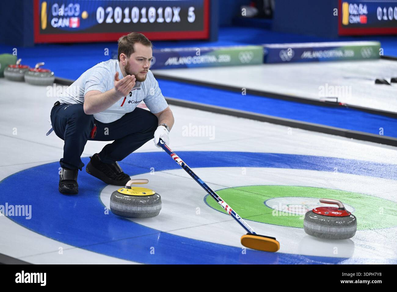 Luc Violette of Team USA guides the stone as they play agains Team ...