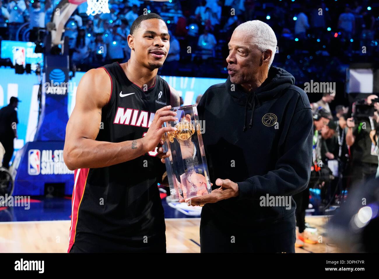 Miami Heat forward Keshad Johnson gets the winner's trophy from Julius ...