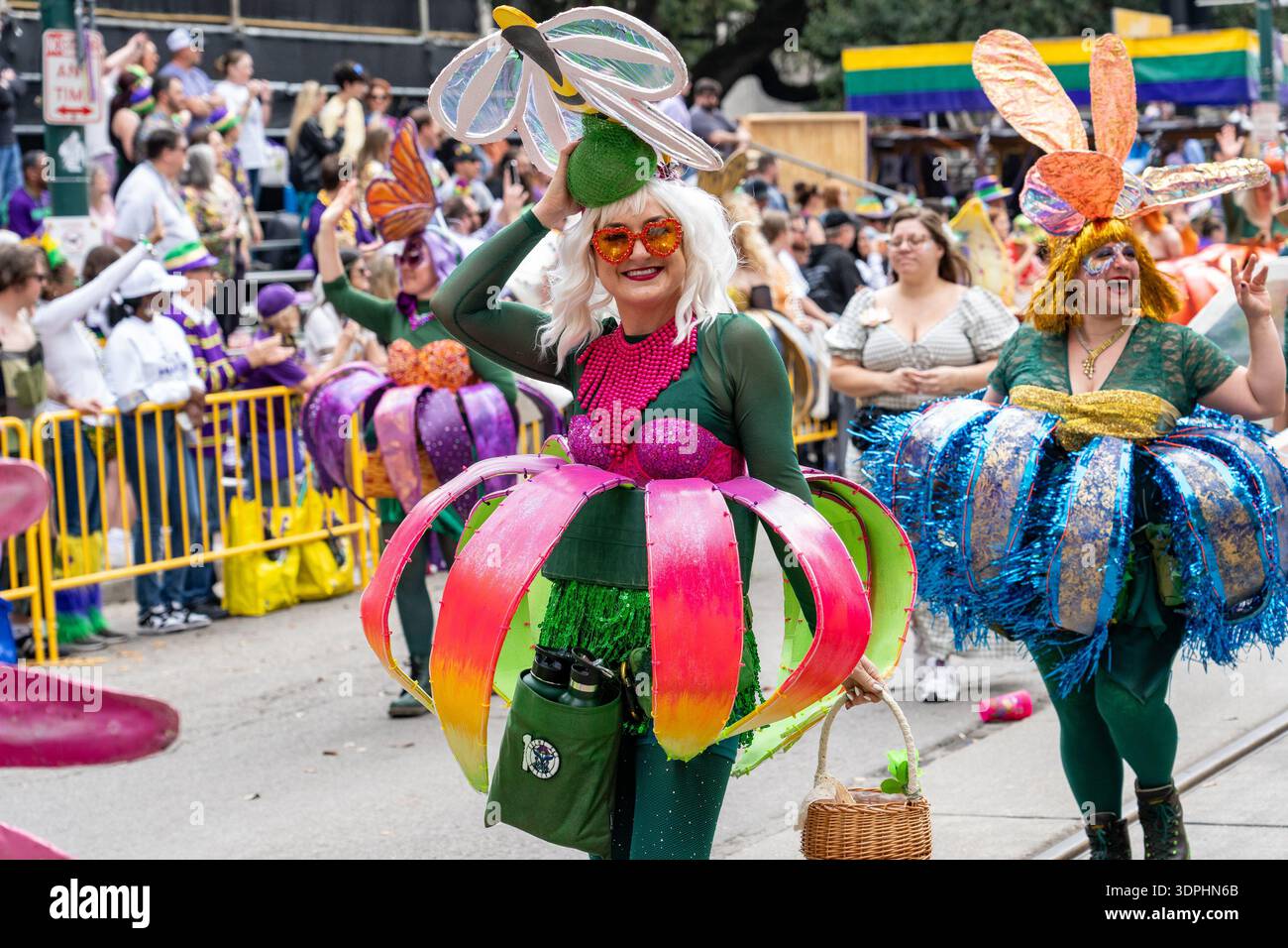 Attendees march during the annual Krewe of Iris parade during the Mardi ...