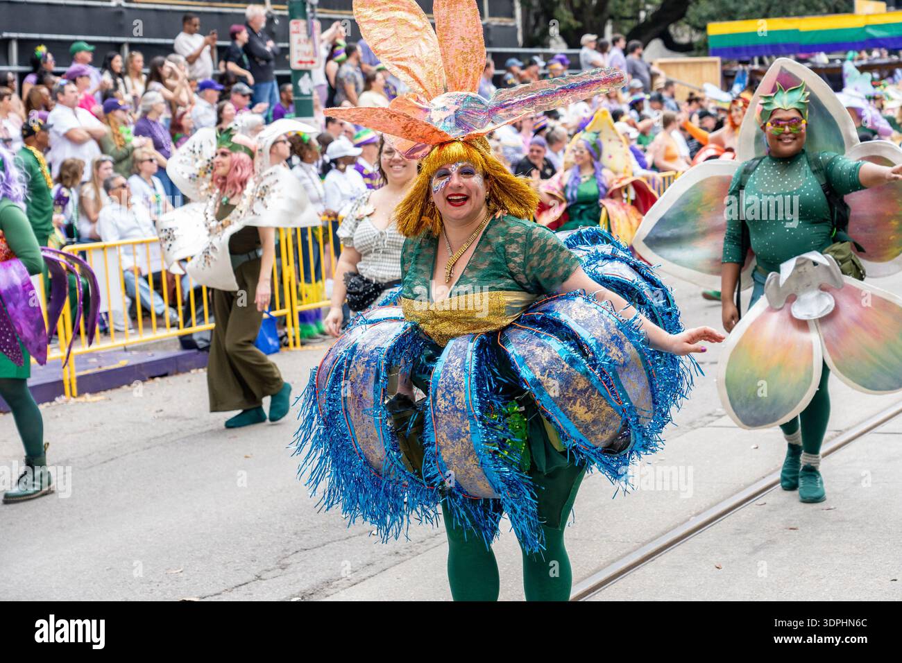 Attendees march during the annual Krewe of Iris parade during the Mardi ...