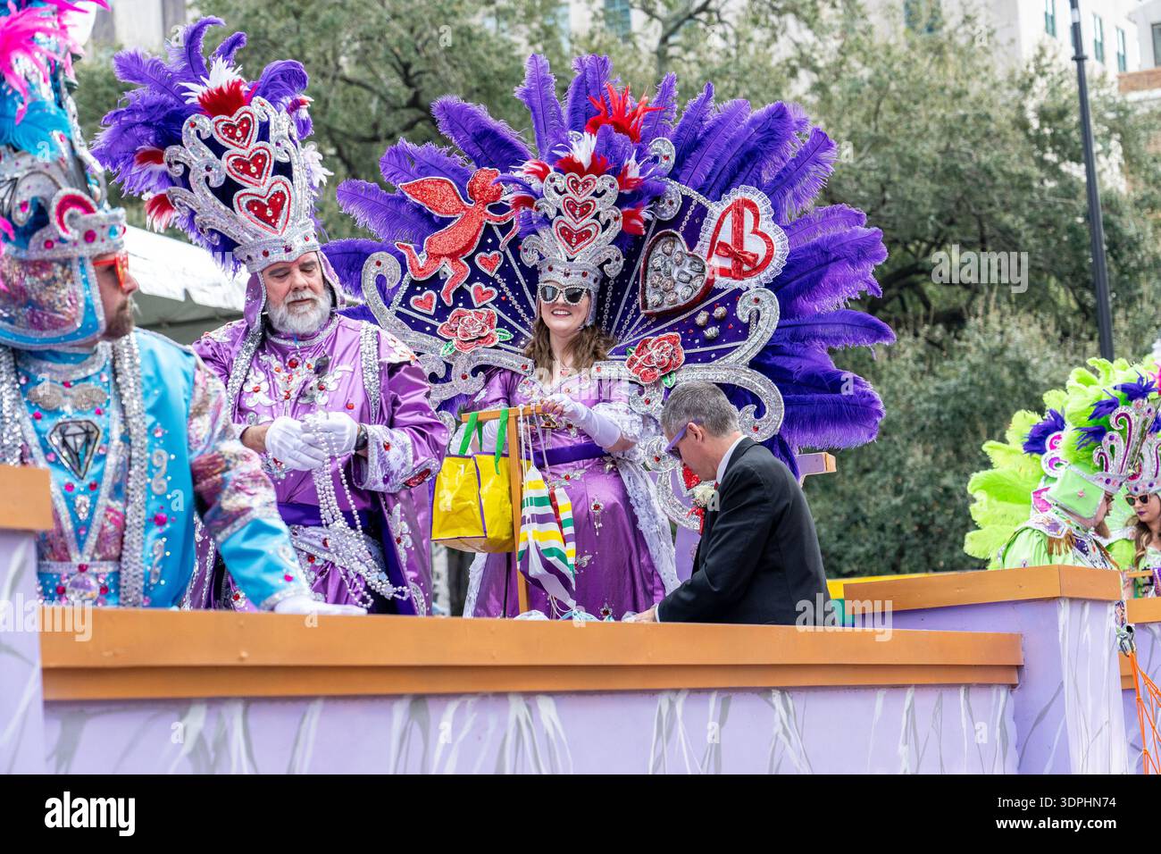 Attendees march during the annual Krewe of Iris parade during the Mardi ...