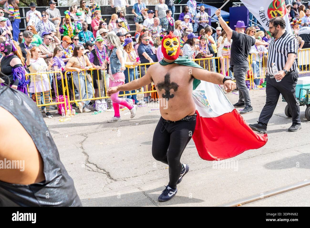 Attendees march during the annual Krewe of Iris parade during the Mardi ...