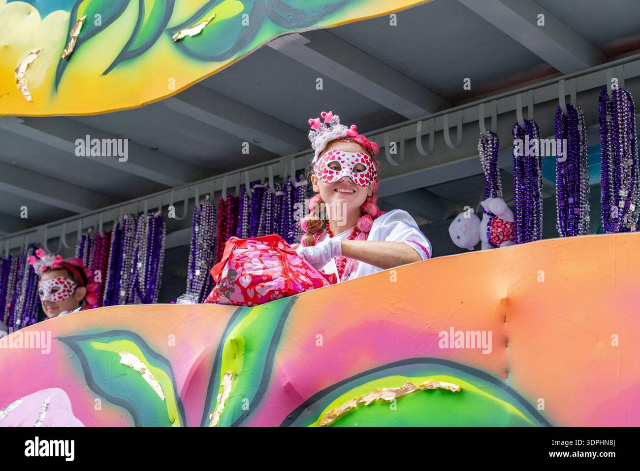 Attendees march during the annual Krewe of Iris parade during the Mardi ...