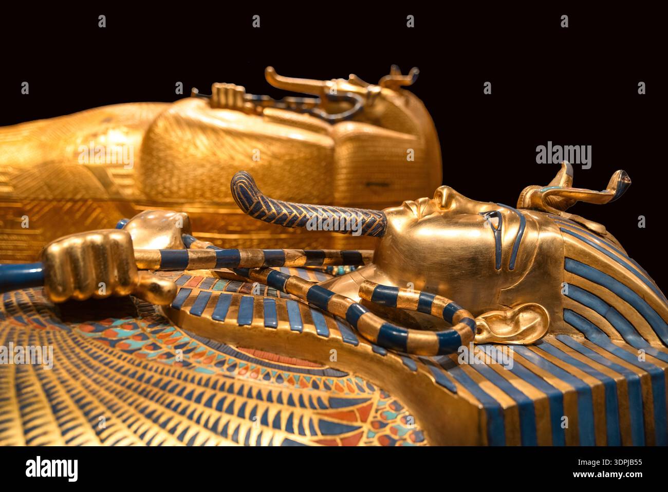 Side close up view of golden funerary mask of Tutankhamun with crossed ...