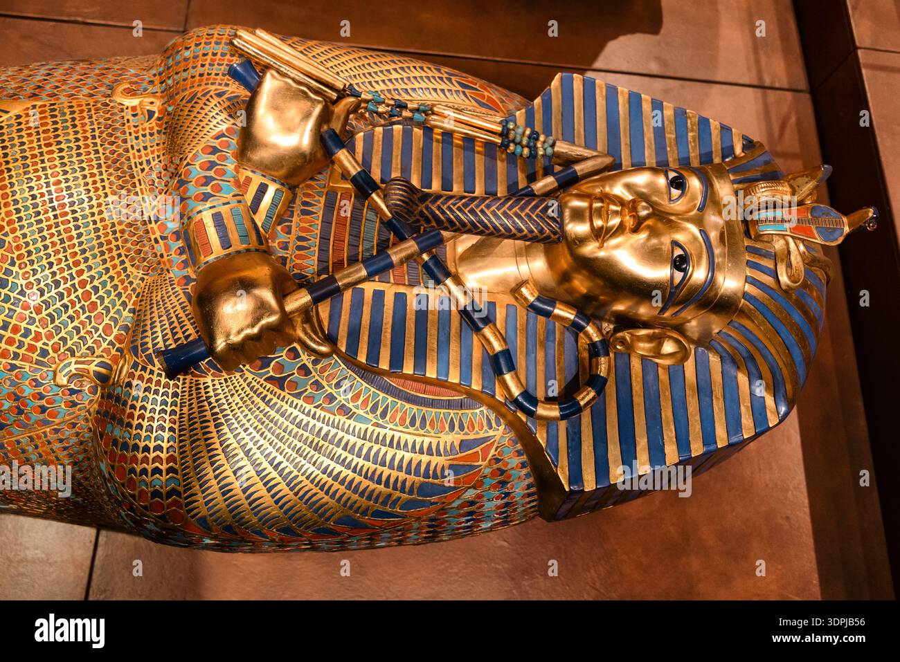 Close up of golden funerary mask of Tutankhamun with blue stripes and ...