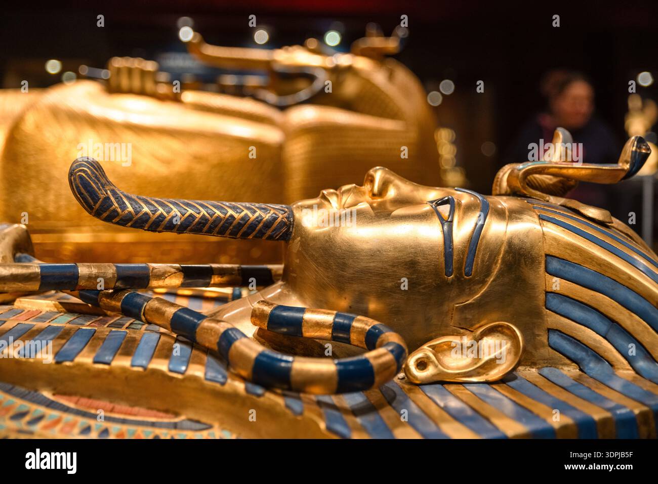 Close up detail of golden funerary mask of Tutankhamun with blue ...