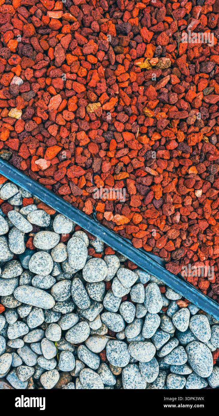 Red Volcanic Lava Rocks and White Garden Pebbles Separated by Edging ...