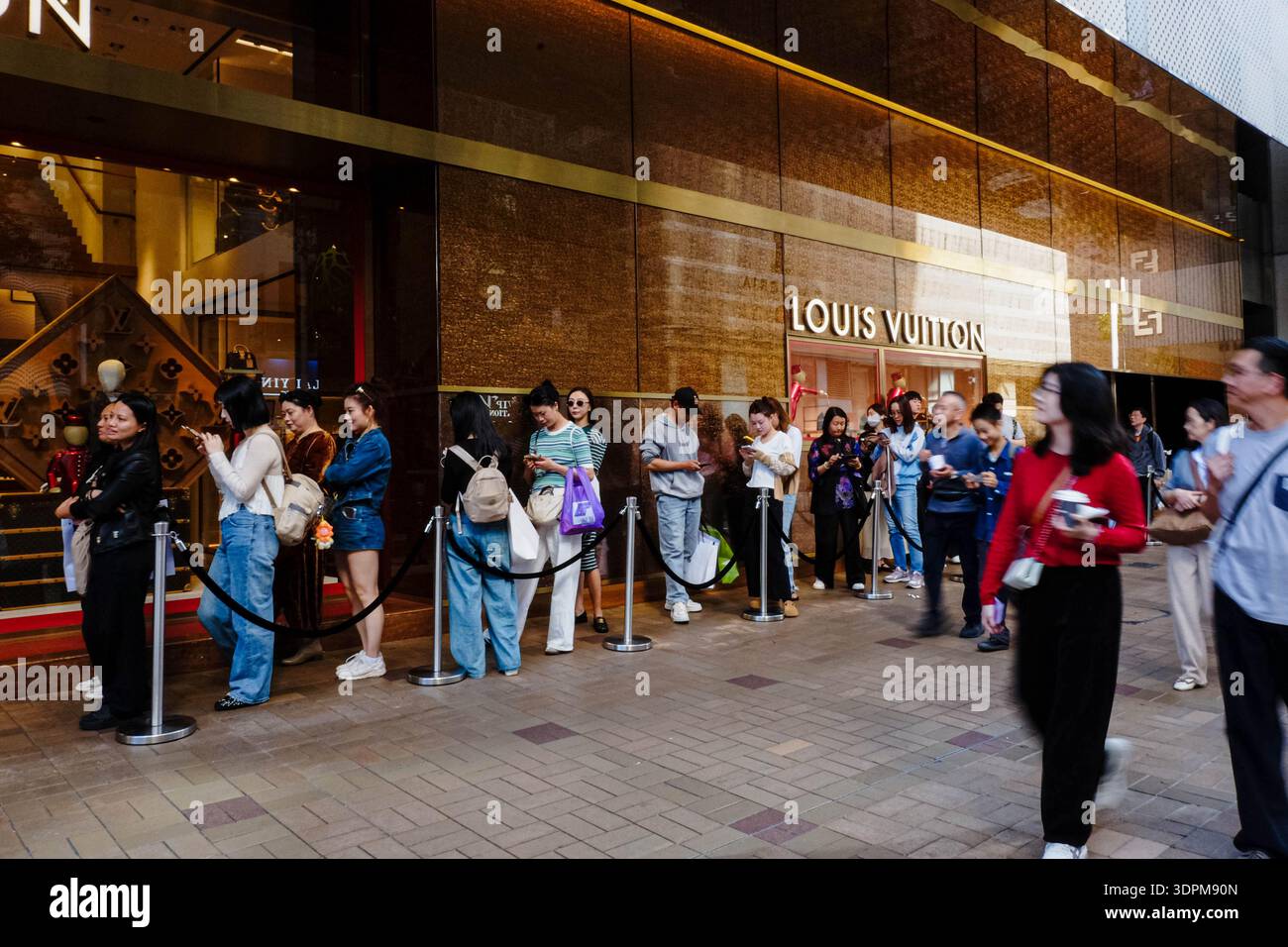 February 15, 2026, Hong Kong, China: Customers wait in line to enter ...