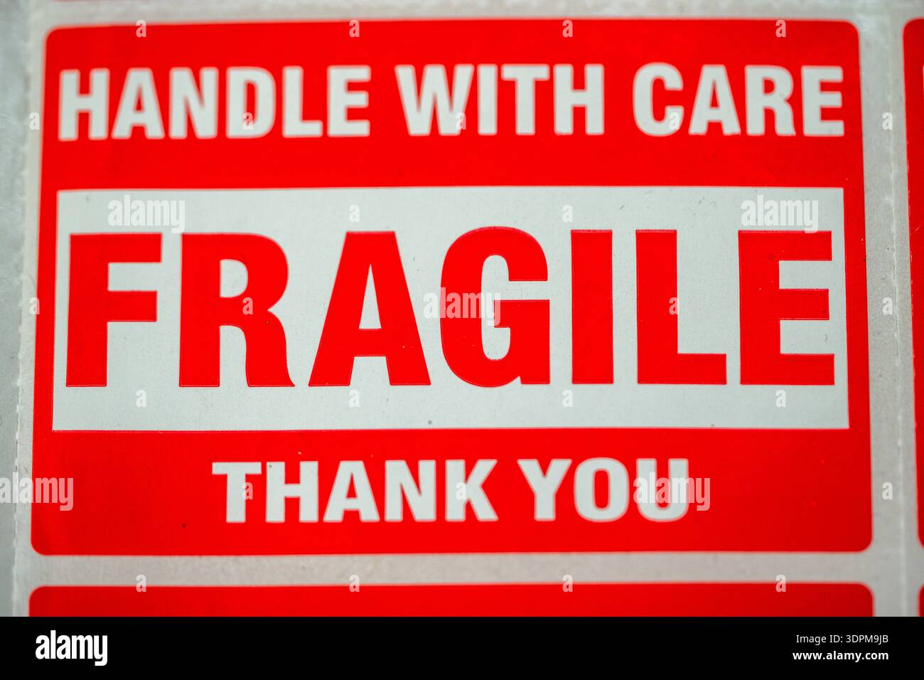 Bright red handle with care signs indicate fragile items that need ...