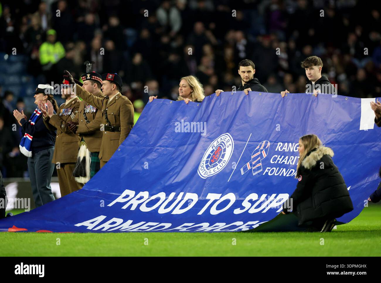 Member of the armed forces take part in a parade on the pitch at half ...
