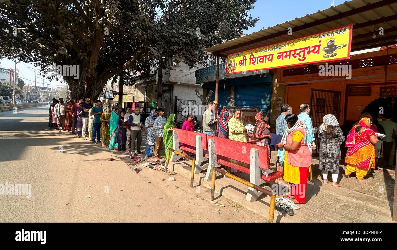 GURUGRAM, INDIA - FEBRUARY 15: Devotees stand in a long queue to offer ...
