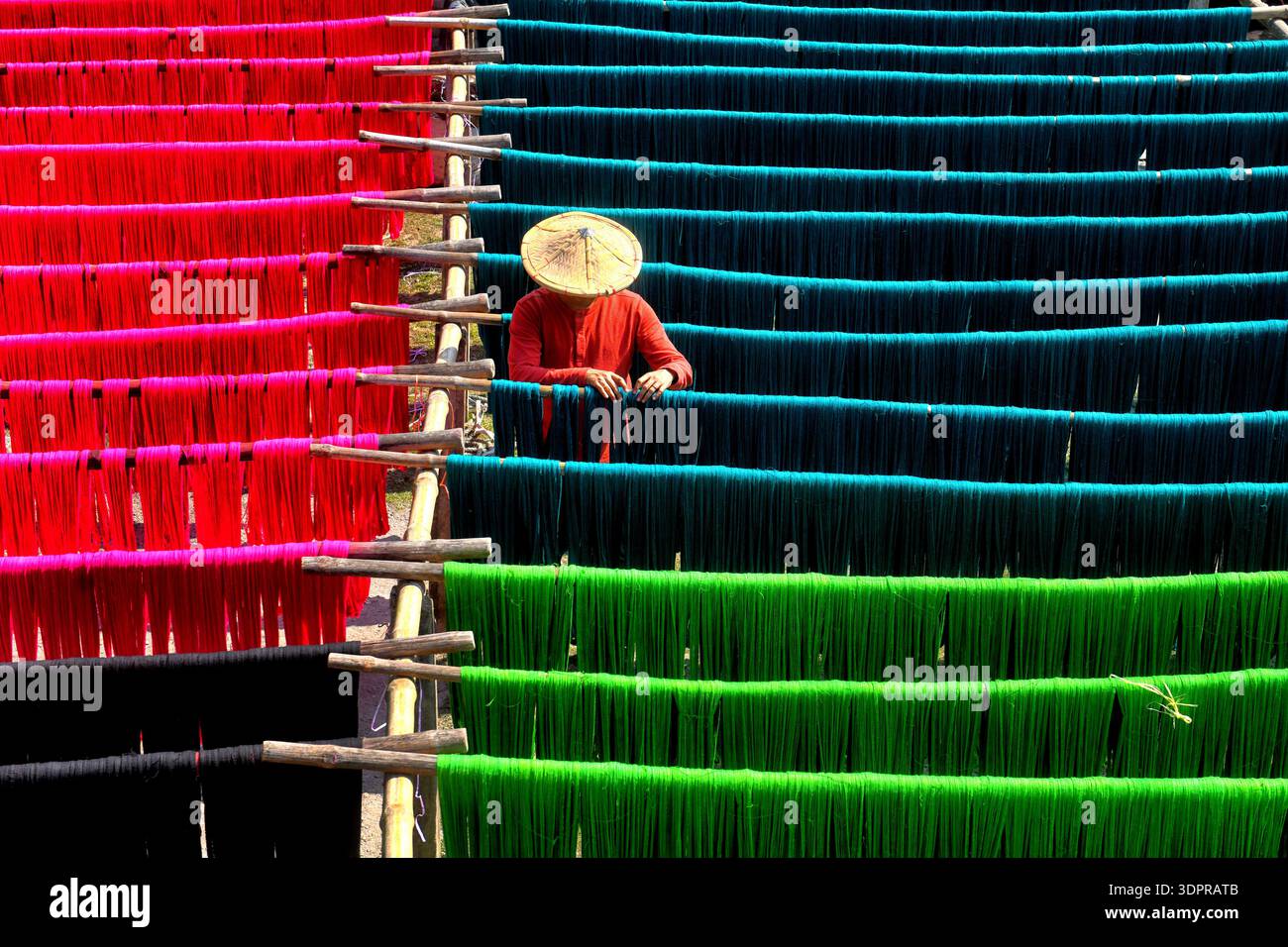 Shantipur, India. 14th Feb, 2026. A worker seen placing the colourful ...