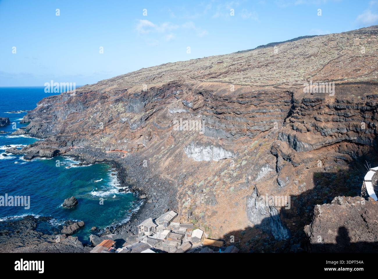 Steep volcanic cliffs, ancient lava flows meet the turquoise ocean, El ...