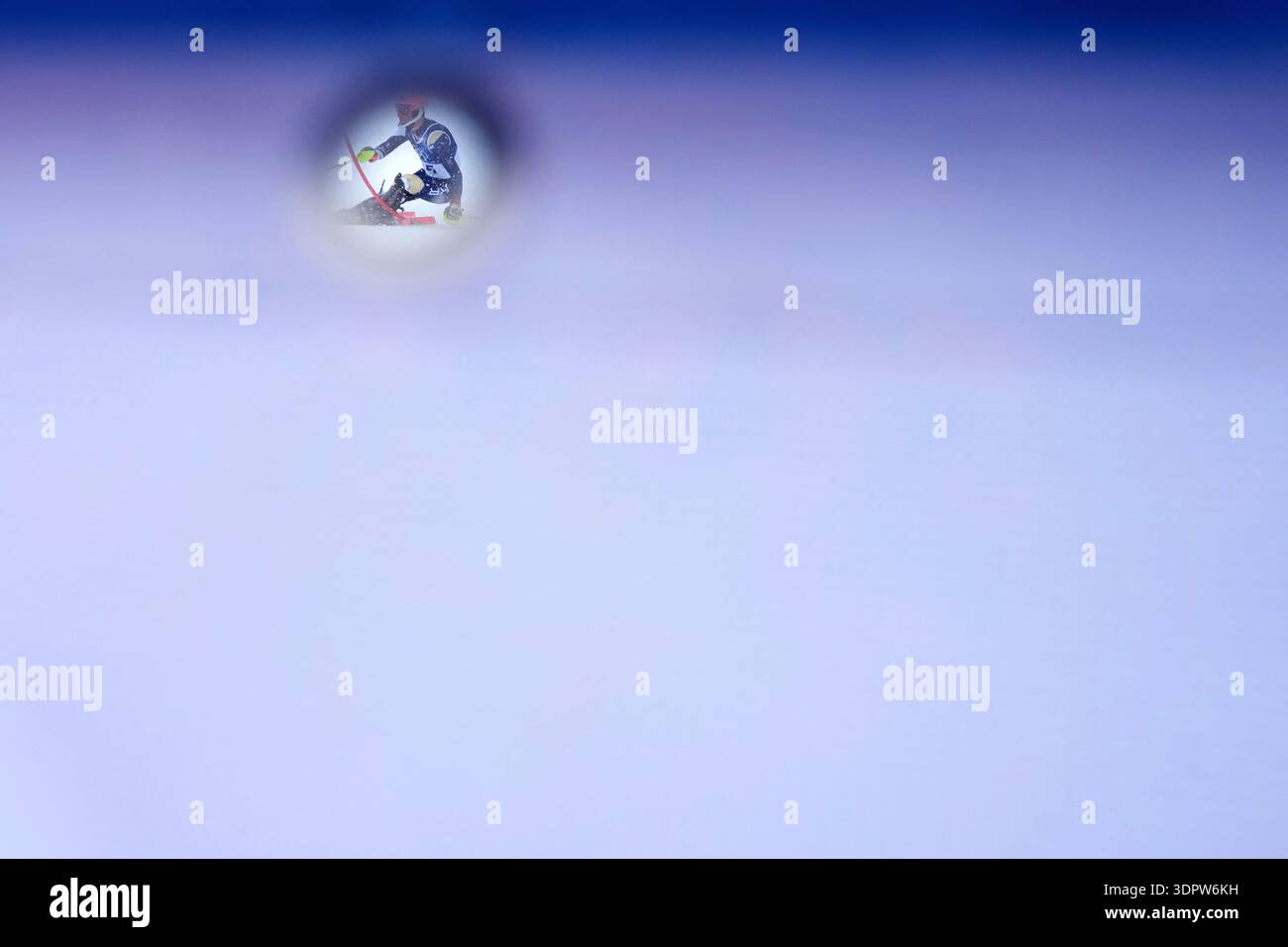Ukraine's Dmytro Shepiuk is seen through a hole in the sideline netting ...